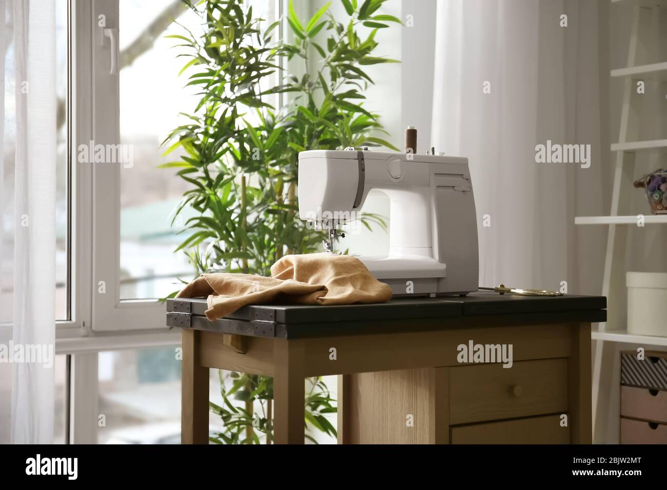 Tailor desk with modern sewing machine Stock Photo - Alamy