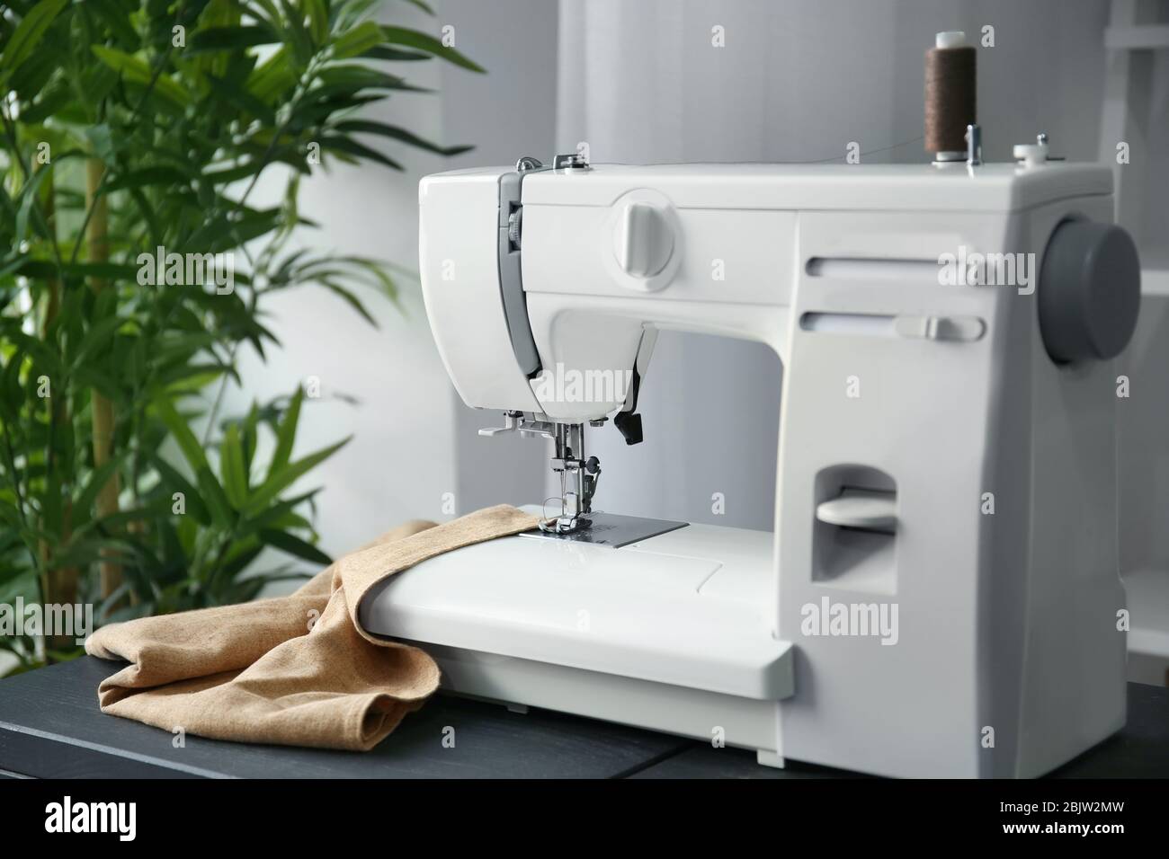 Tailor desk with modern sewing machine Stock Photo - Alamy