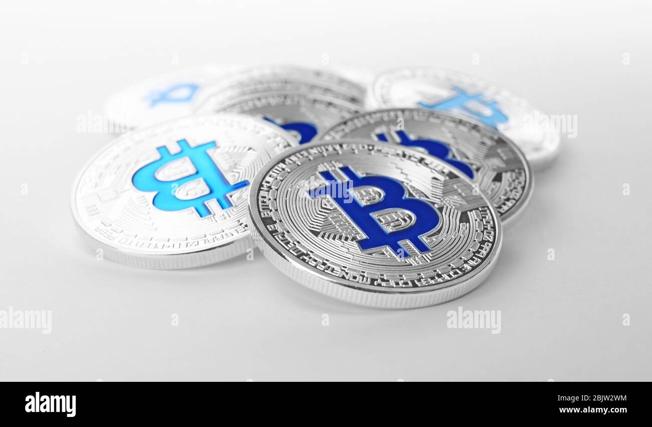 Silver bitcoins on white background Stock Photo - Alamy