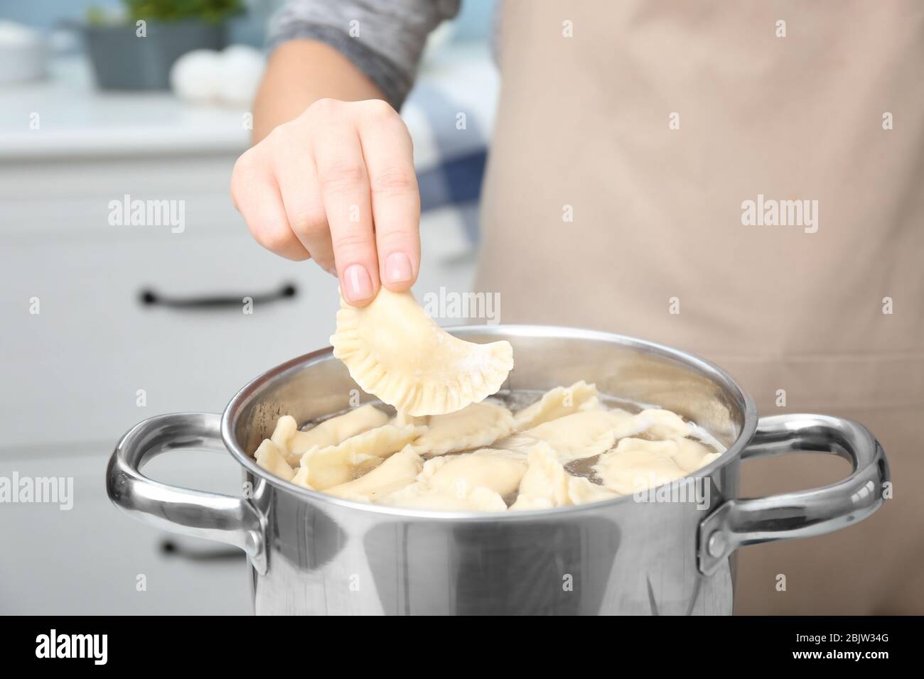 Woman cooking dumplings in hi-res stock photography and images - Alamy