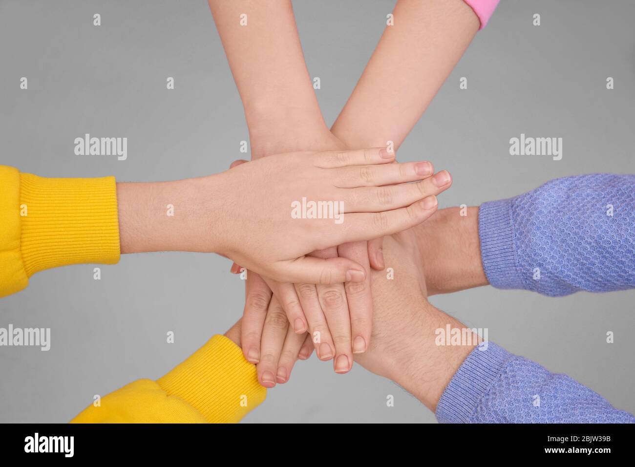 People holding hands together on light background. Unity concept Stock ...