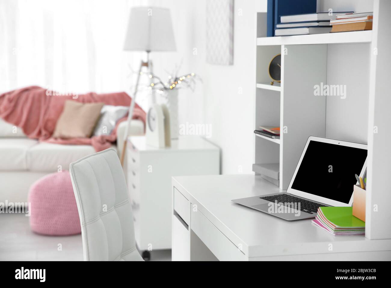Student room interior with laptop on table Stock Photo - Alamy