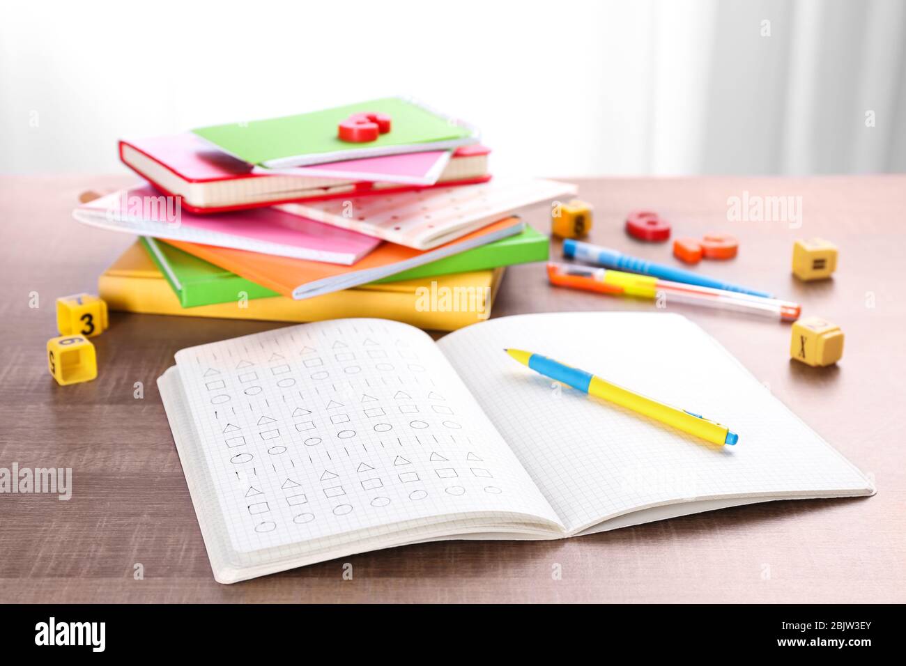 Exercise book with homework on table Stock Photo - Alamy