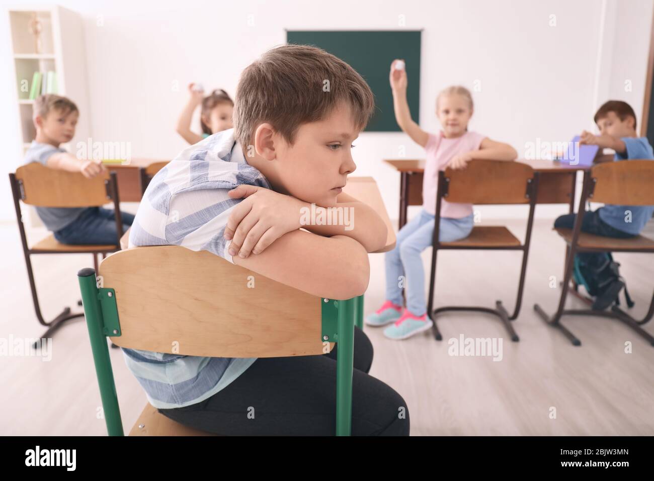 School children in classroom throwing hi-res stock photography and ...