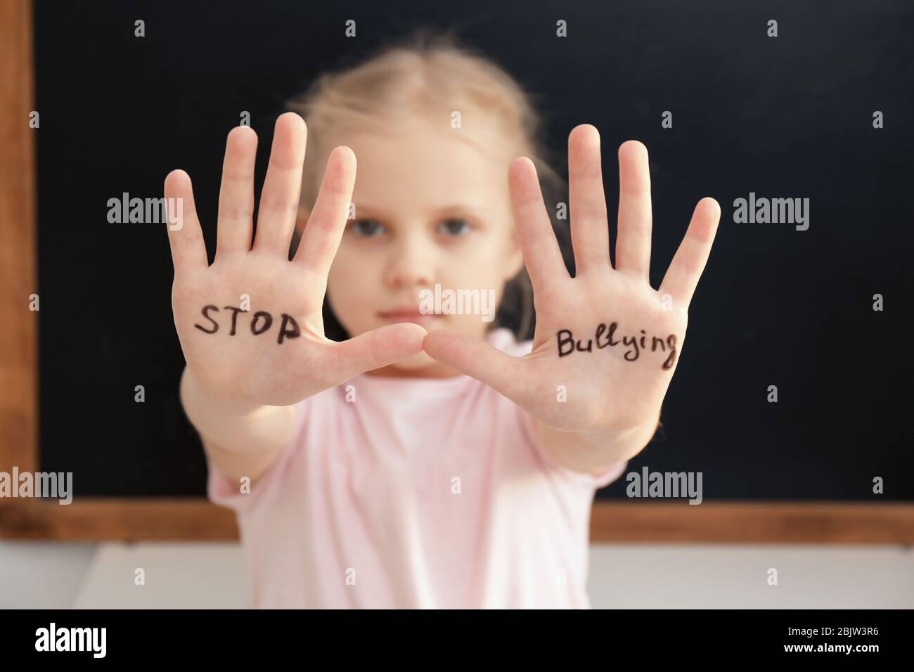 Little girl with words "Stop bullying" on dark background Stock Photo ...