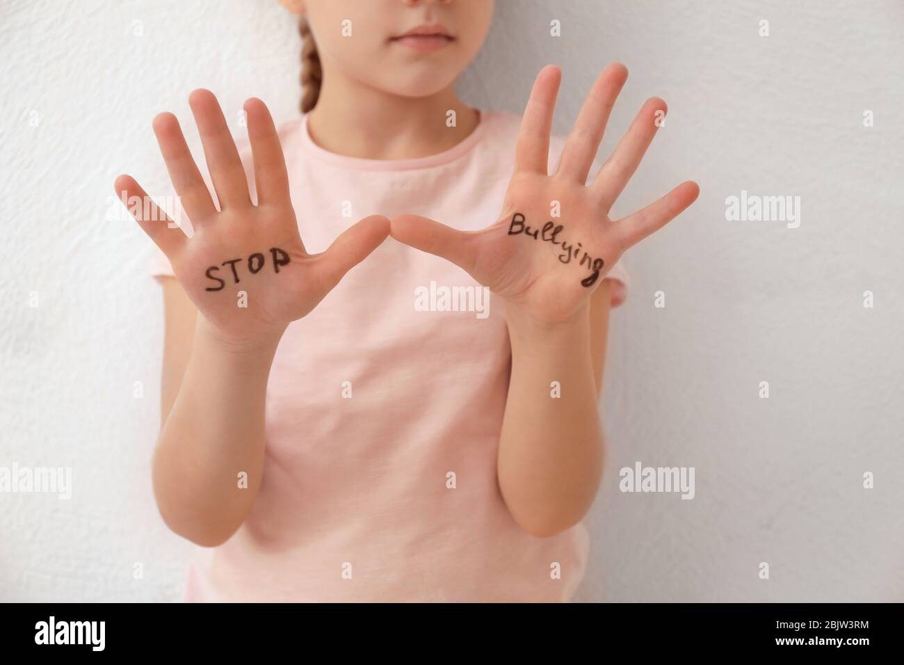 Little girl with words "Stop bullying" on light background Stock Photo ...