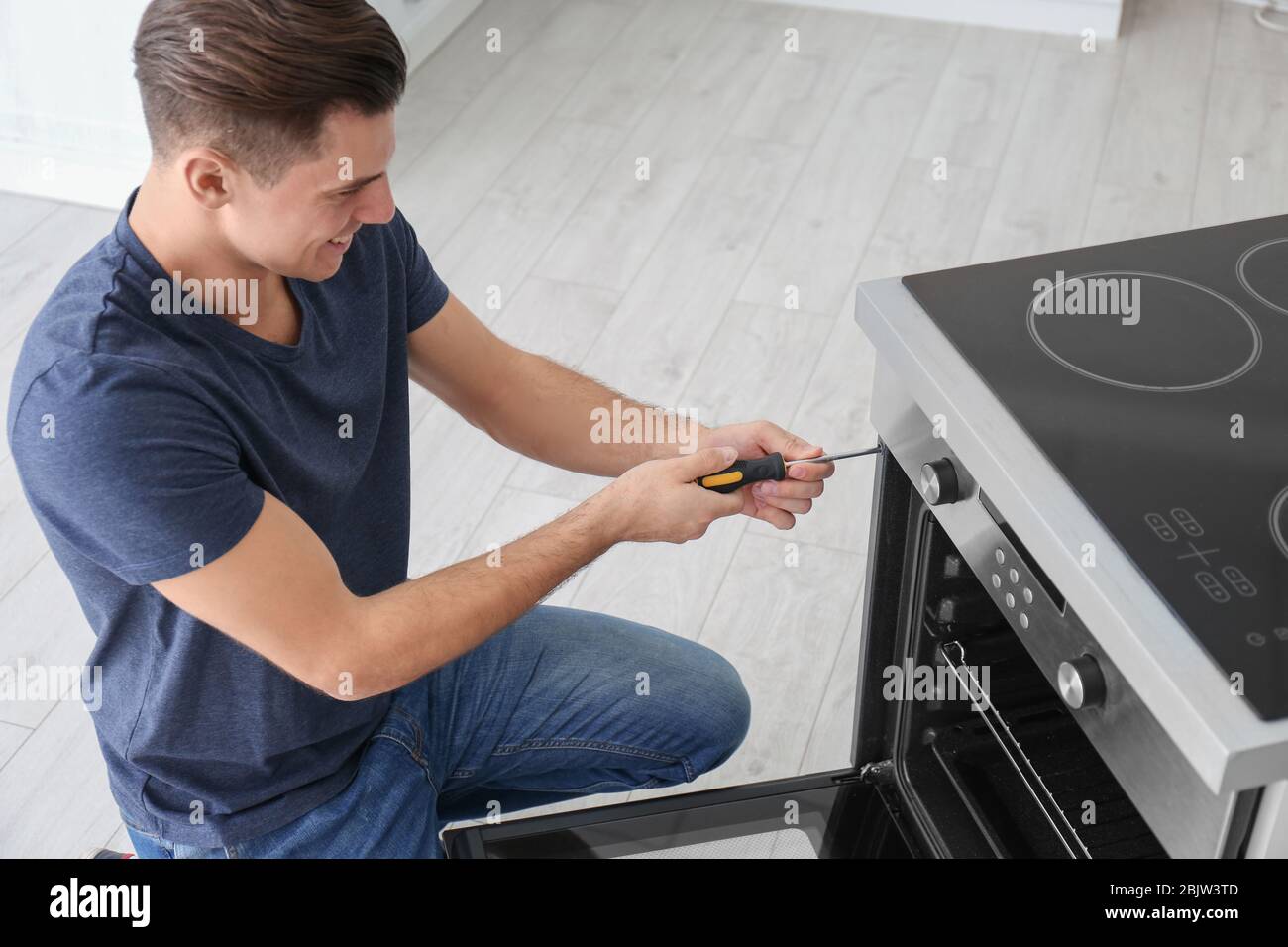Man repairing oven hi-res stock photography and images - Alamy
