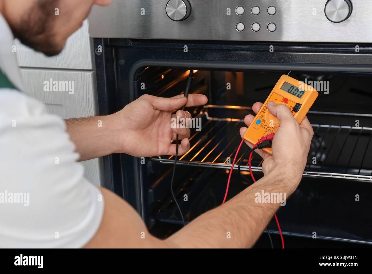 Young technician using multimeter hi-res stock photography and images ...