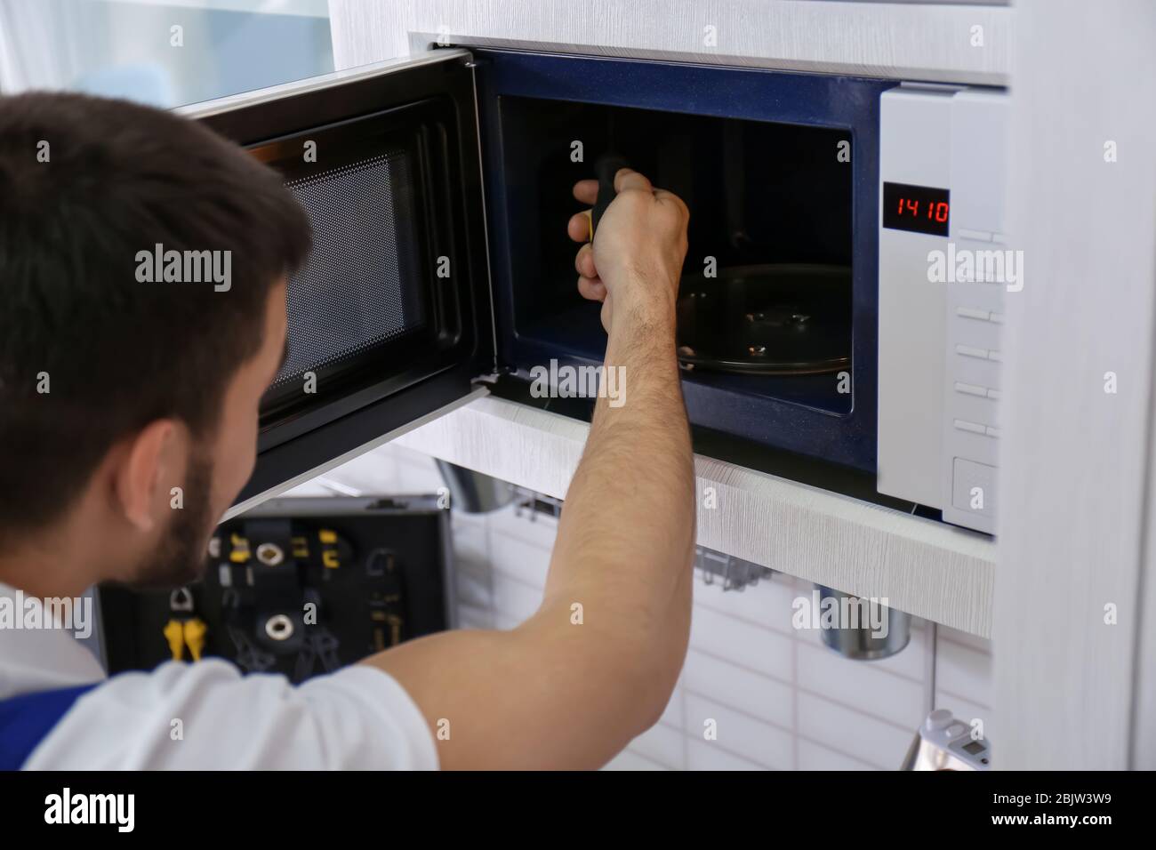 Microwave oven man hi-res stock photography and images - Alamy