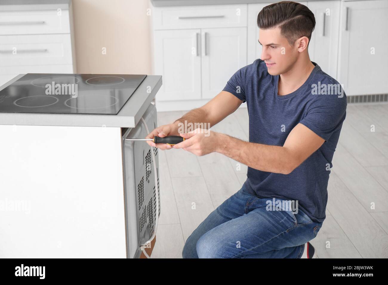 Man repairing oven hi-res stock photography and images - Alamy