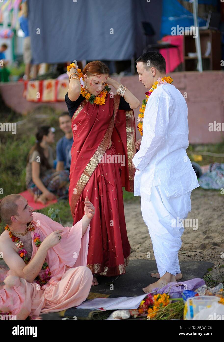 Vedic wedding. Bride and groom in wedding dresses standing on the ...