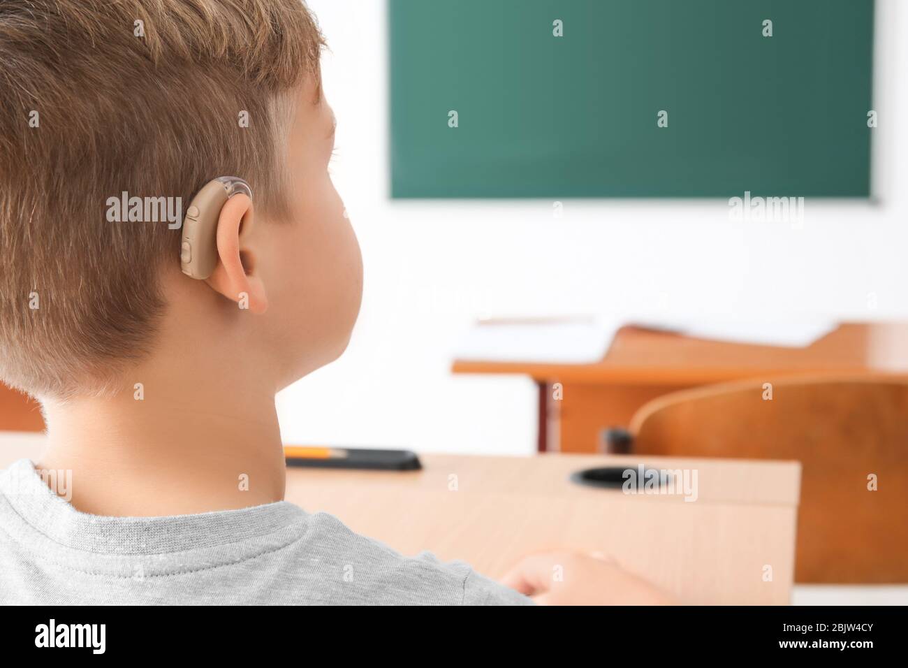 Little boy with hearing aid, closeup Stock Photo - Alamy