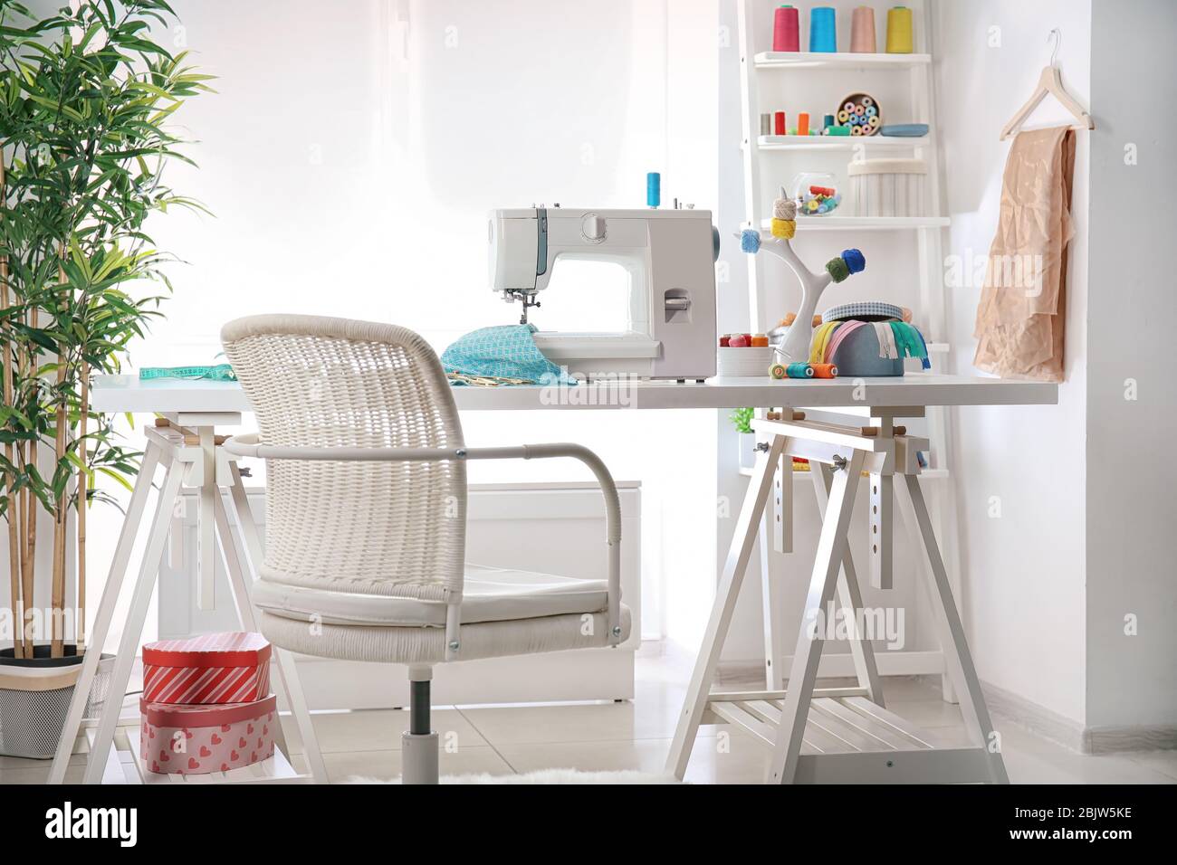 Sewing machine with fabric on table in tailor workshop Stock Photo - Alamy