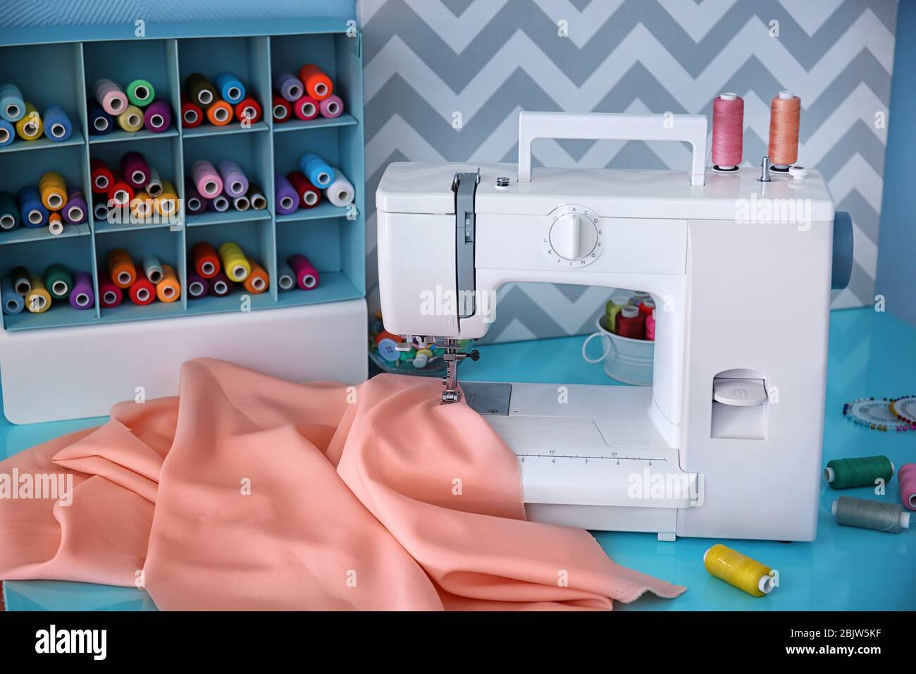 Sewing machine with fabric on table in tailor workshop Stock Photo - Alamy