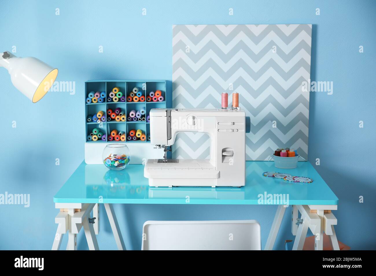 Sewing machine with fabric on table in tailor workshop Stock Photo - Alamy