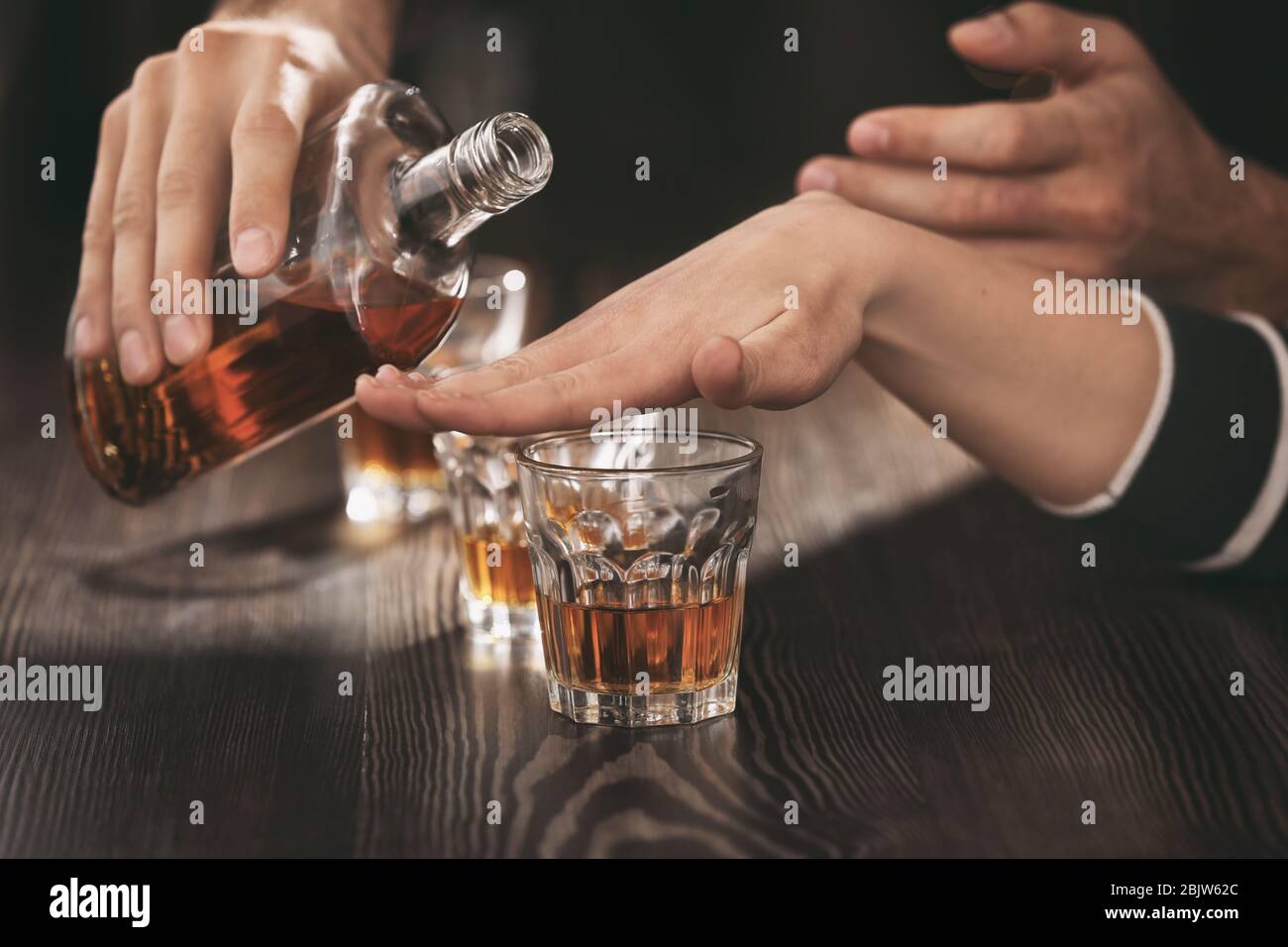 Woman refusing to drink alcohol in bar Stock Photo - Alamy