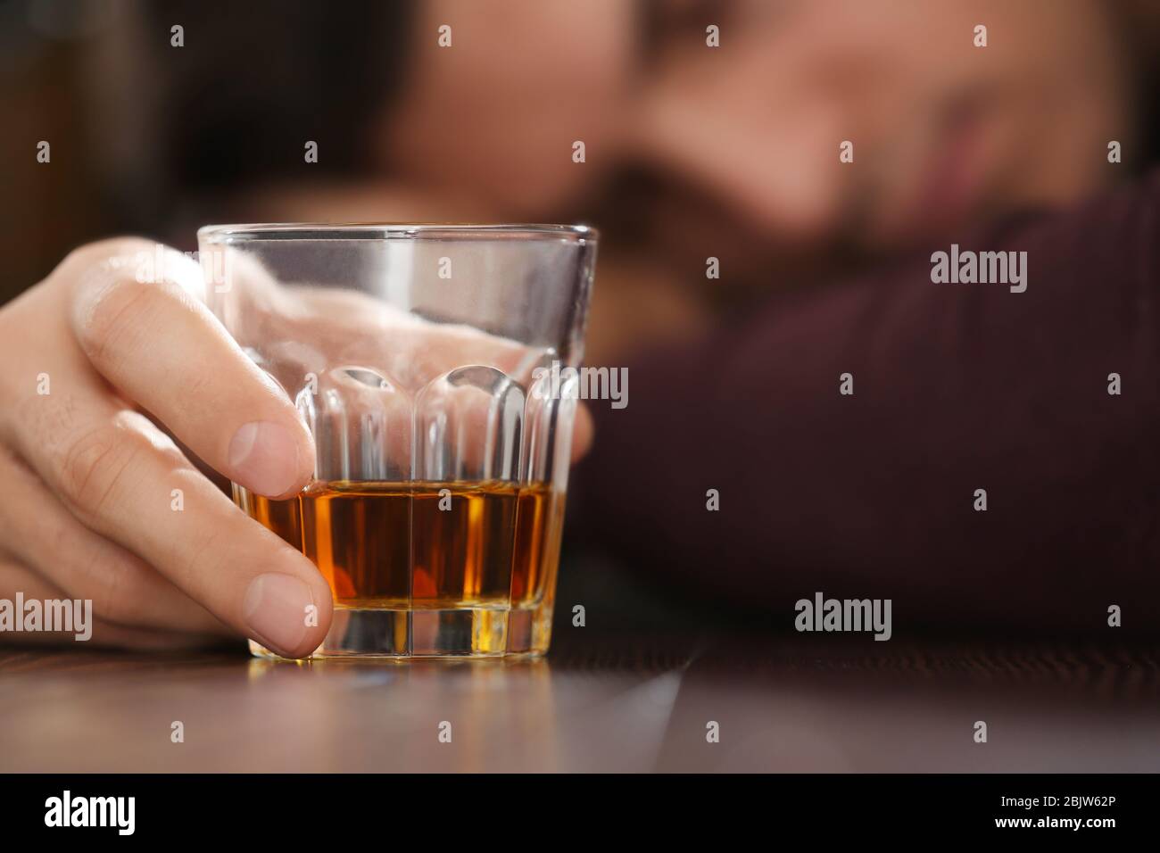 Unconscious drunk man with glass of alcohol in bar, closeup. Alcoholism ...