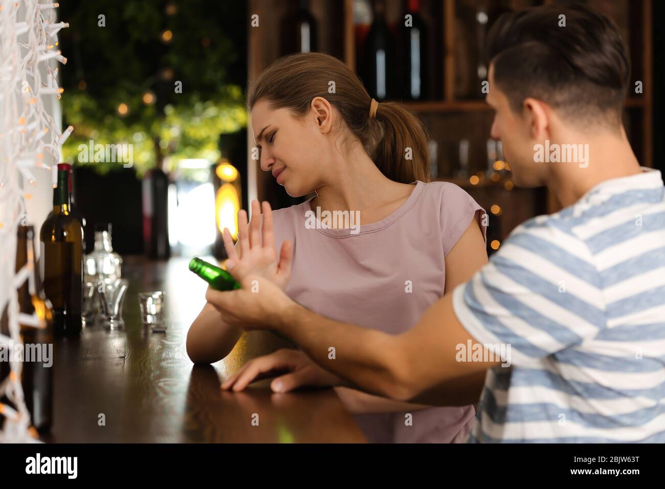 Woman rejecting man at bar hi-res stock photography and images - Alamy