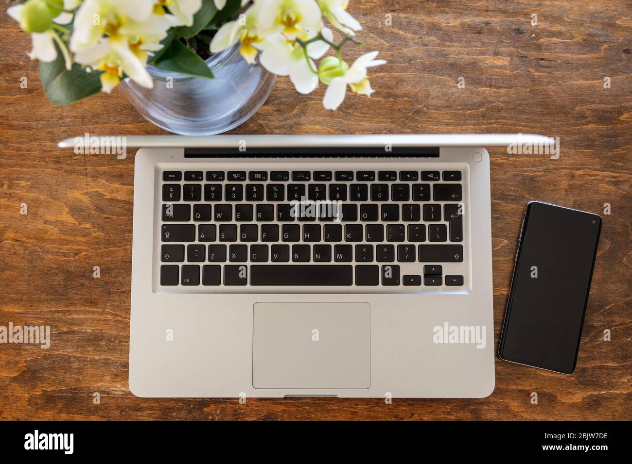 Workplace. Computer laptop and mobile phone on a wood office desk, work ...