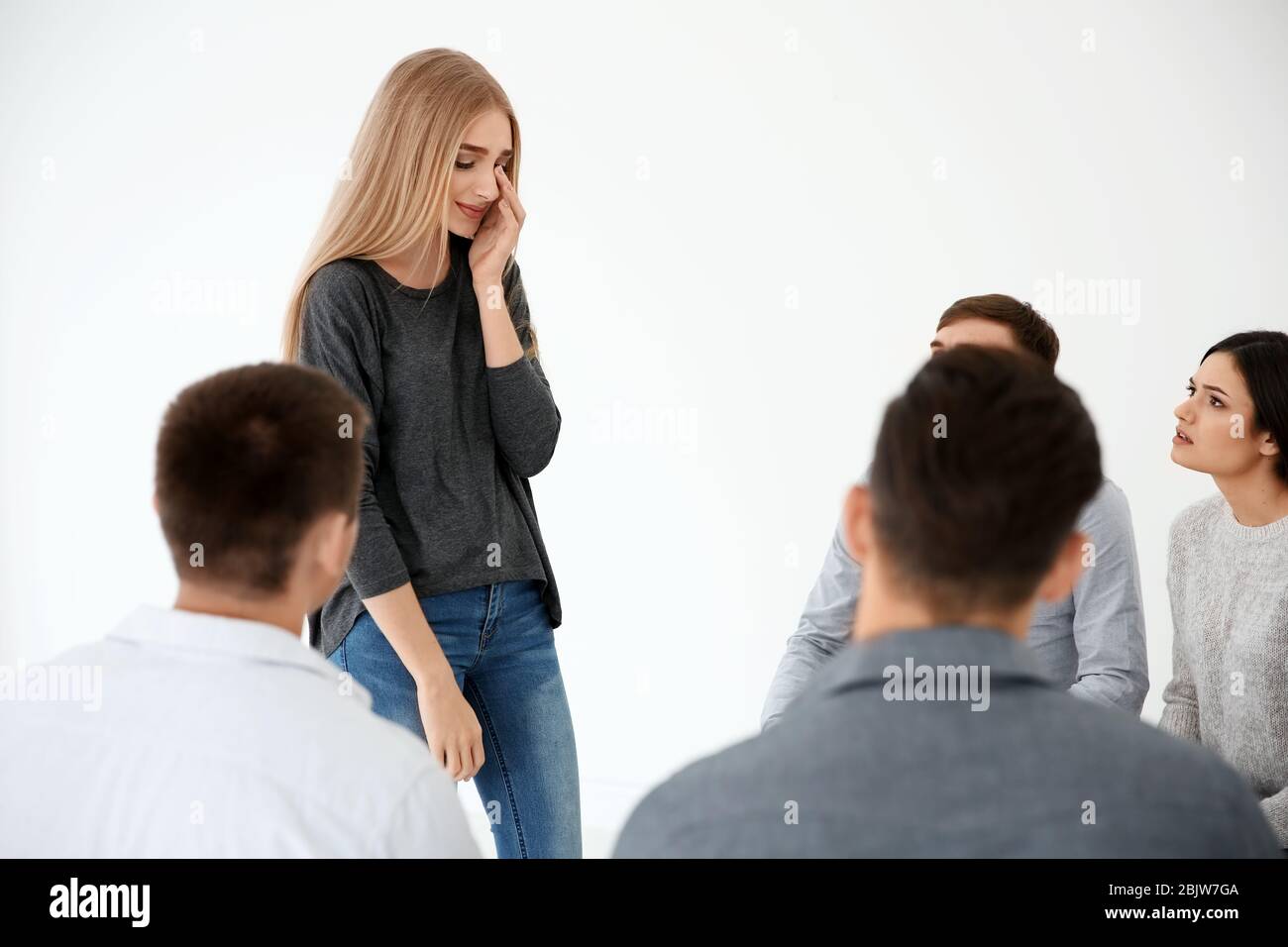 Young woman talking about her problems during group therapy Stock Photo ...