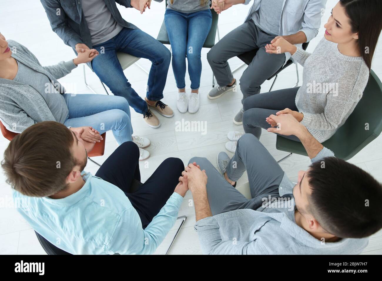 People holding hands together, indoors. Group therapy Stock Photo - Alamy