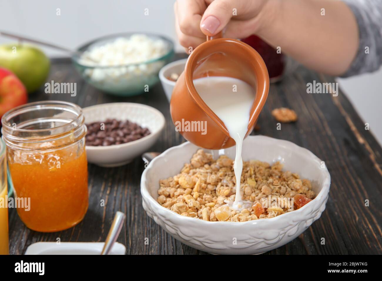 Woman having breakfast at table Stock Photo - Alamy