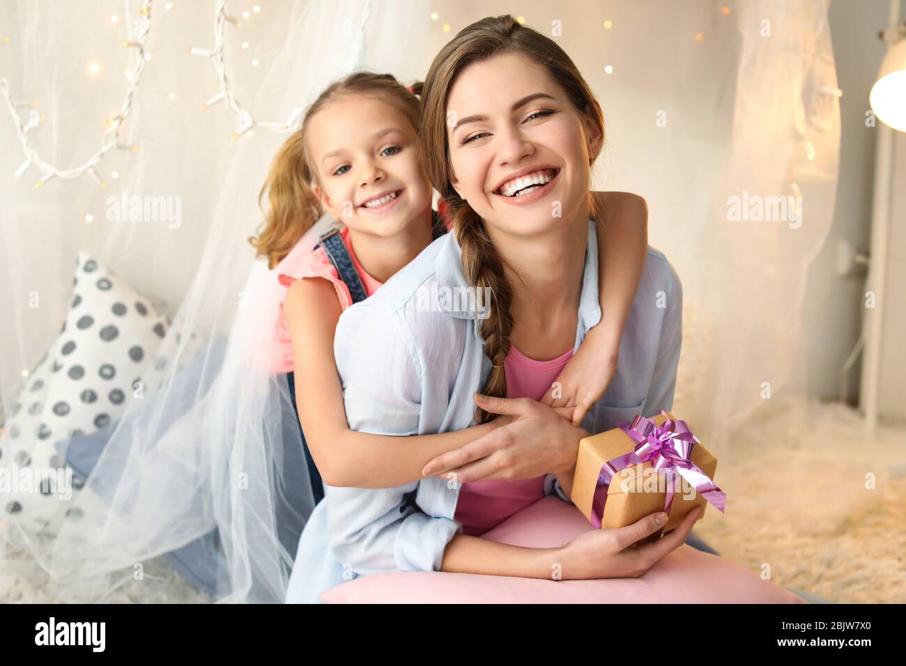 Cute little girl greeting her mother at home Stock Photo - Alamy