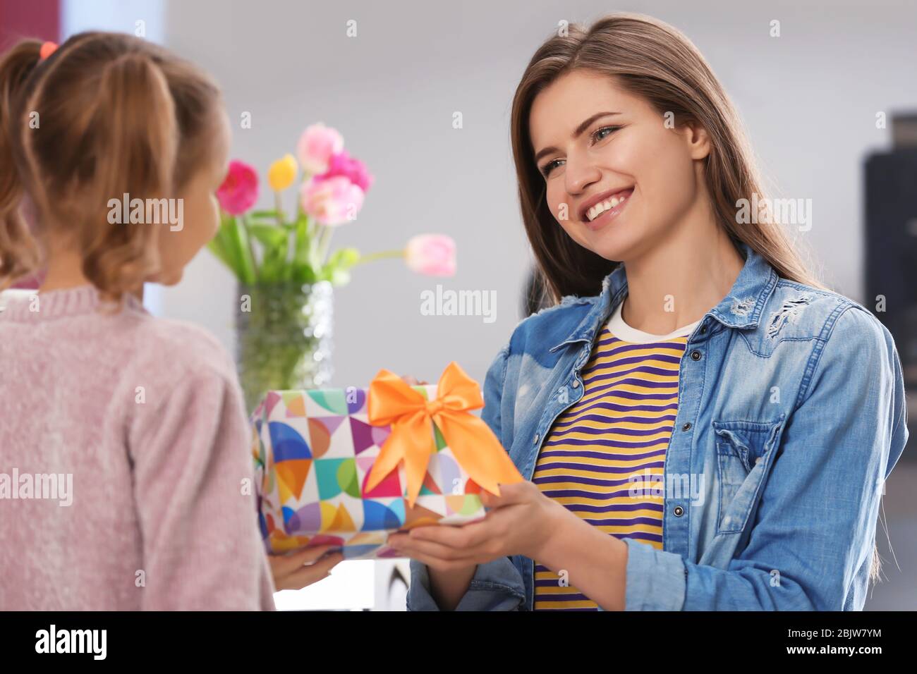Cute little girl greeting her mother at home Stock Photo - Alamy