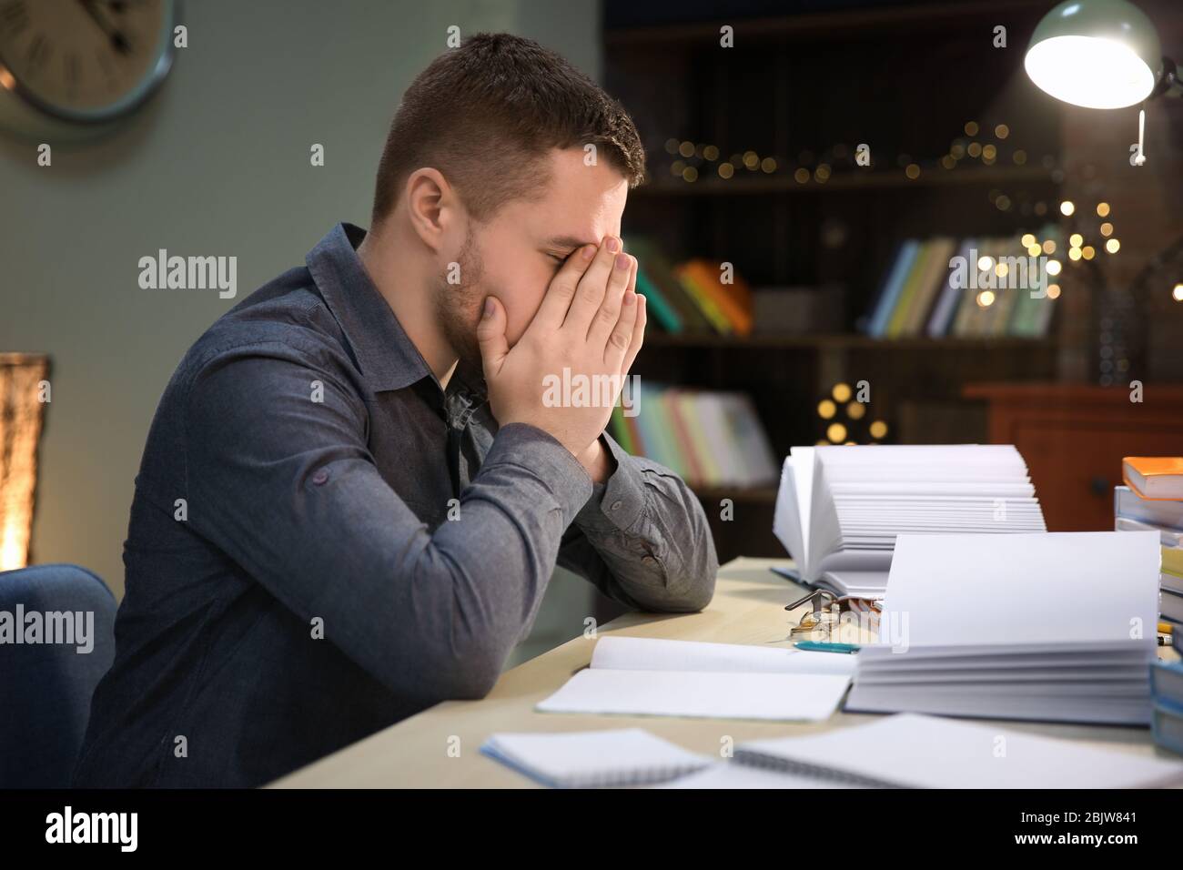Tired student doing homework indoors late at night Stock Photo - Alamy