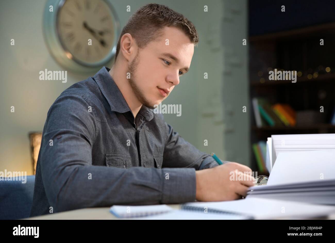 Student doing homework indoors late at night Stock Photo - Alamy