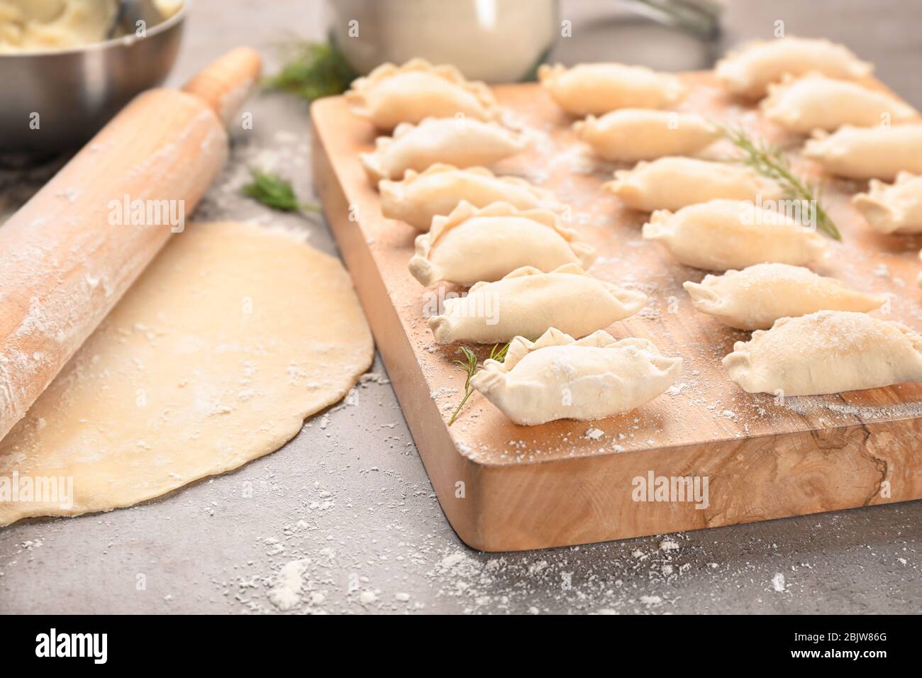 Raw dumplings on wooden board, closeup Stock Photo - Alamy
