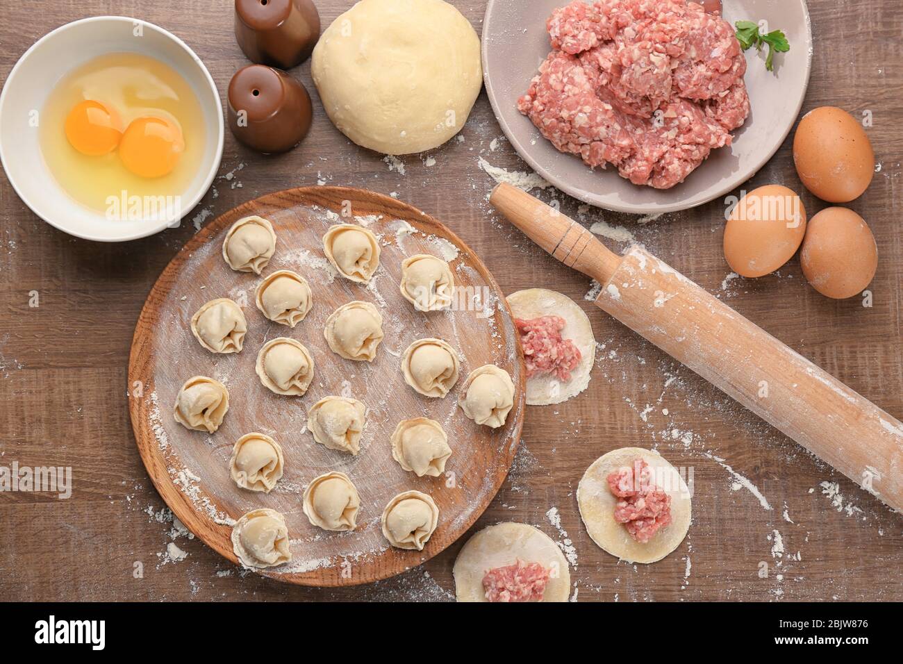 Preparation of dumplings with meat on table, top view Stock Photo - Alamy