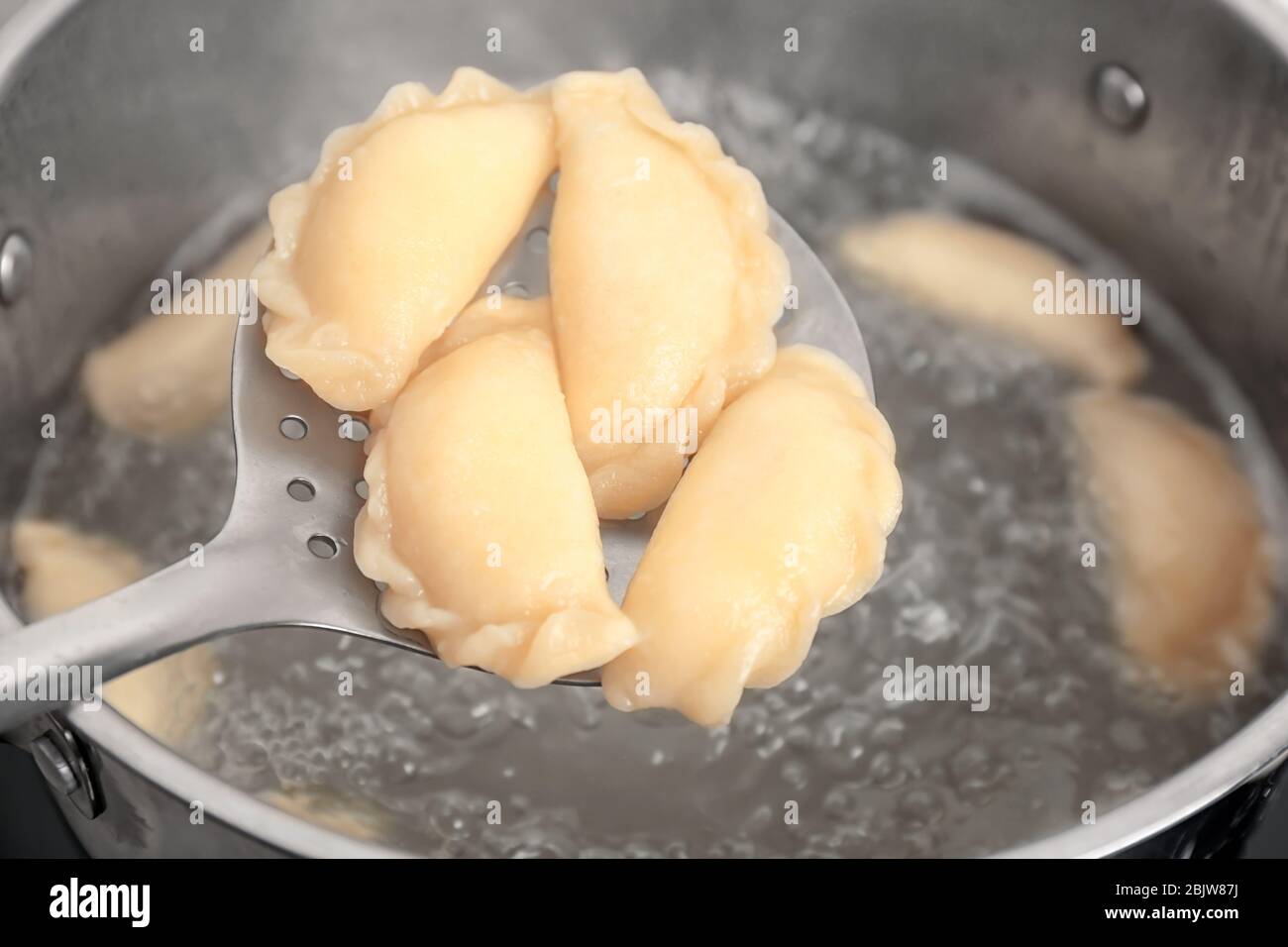 Cooking dumplings in boiling water, closeup Stock Photo - Alamy