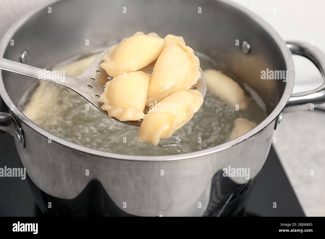 Cooking dumplings in boiling water, closeup Stock Photo - Alamy