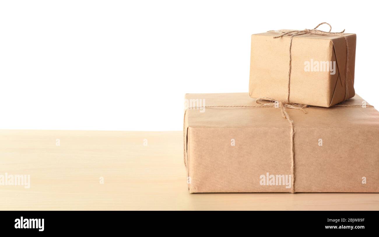Parcel gift boxes on table against white background Stock Photo - Alamy