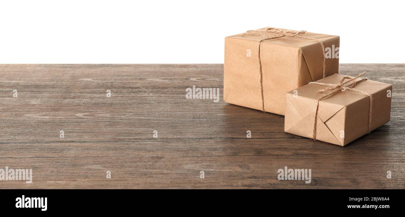 Parcel gift boxes on table against white background Stock Photo - Alamy