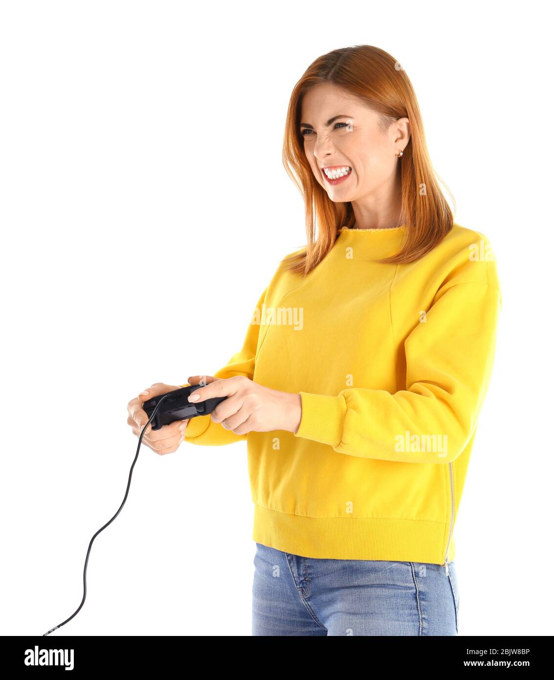 Emotional woman with video game controller on white background Stock ...
