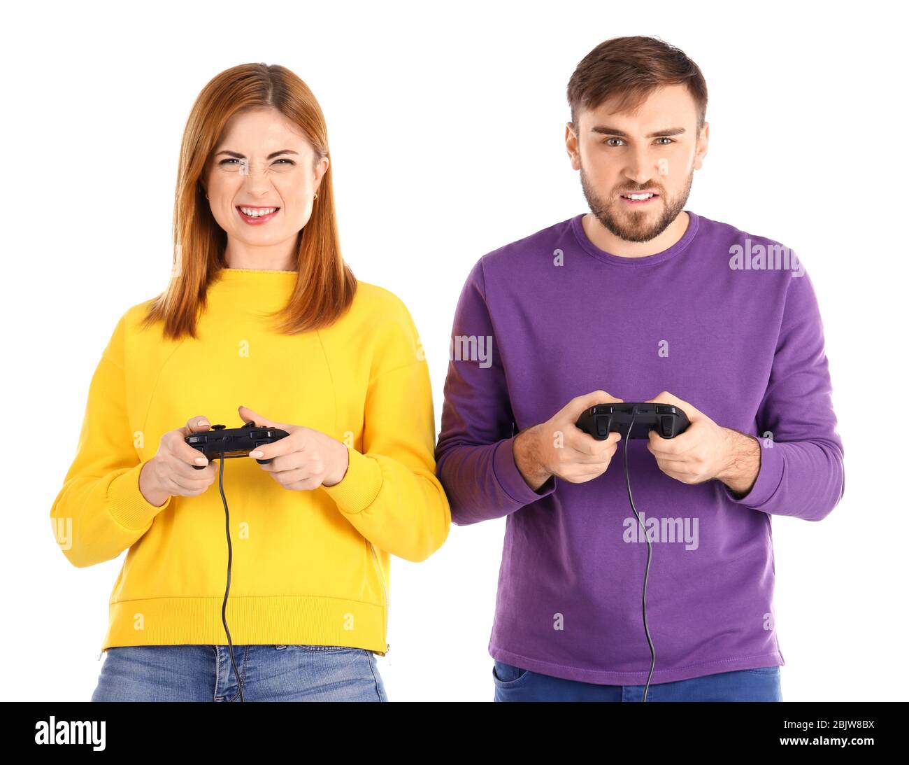 Emotional couple playing video game on white background Stock Photo - Alamy