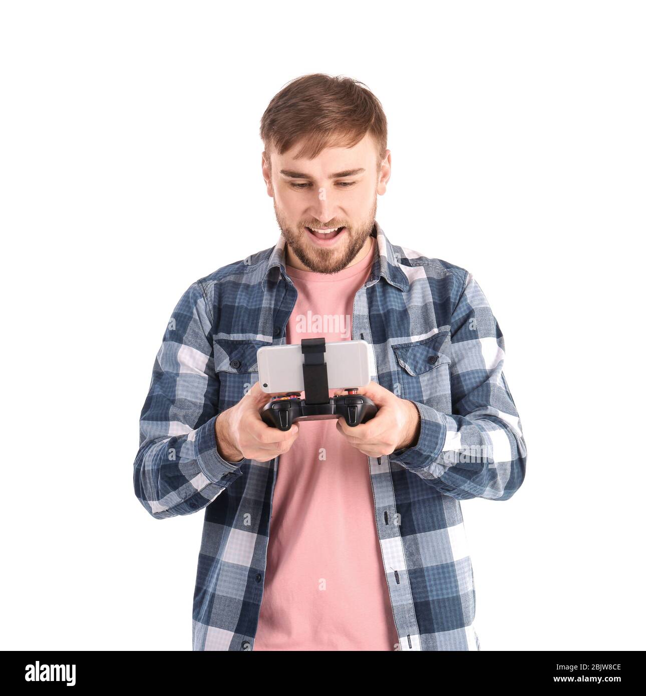 Emotional man with video game controller for smartphone on white ...
