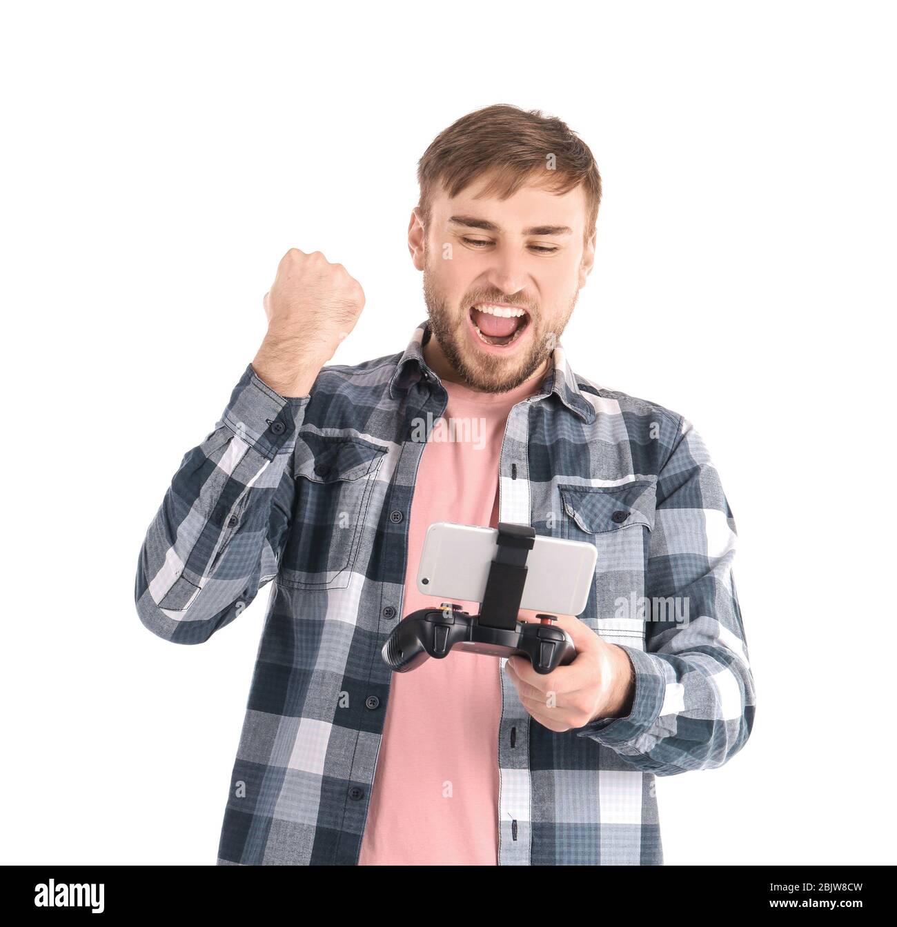 Emotional man with video game controller for smartphone on white ...