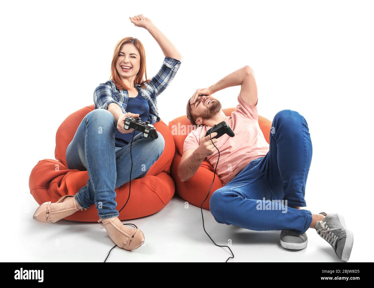 Emotional couple playing video game on white background Stock Photo - Alamy