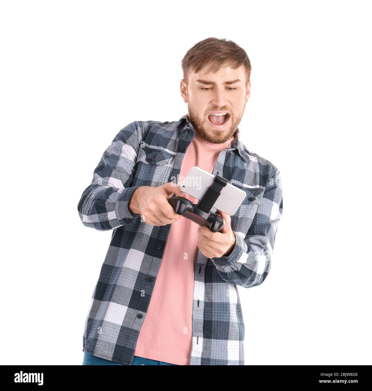 Emotional man with video game controller for smartphone on white ...
