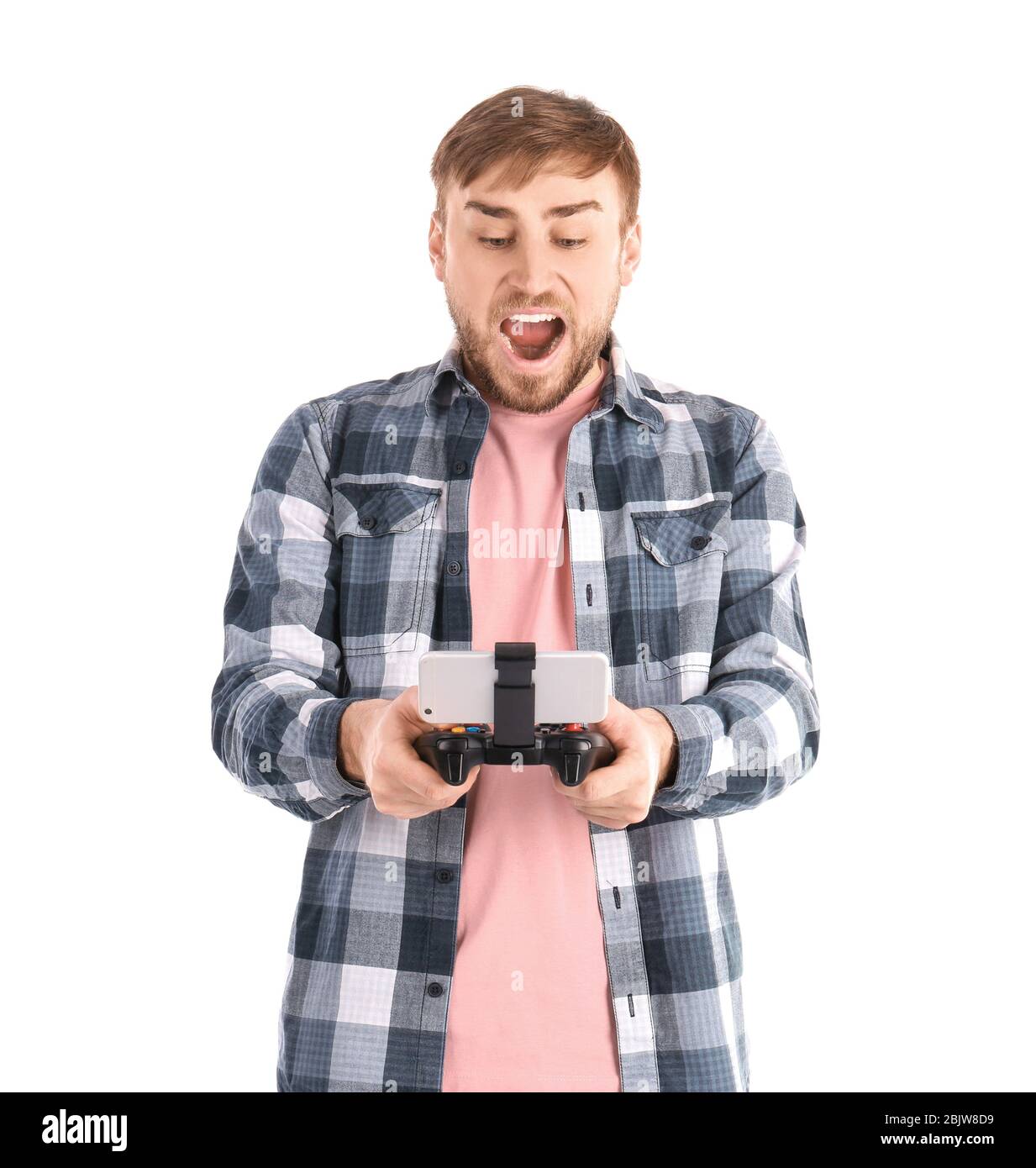 Emotional man with video game controller for smartphone on white ...