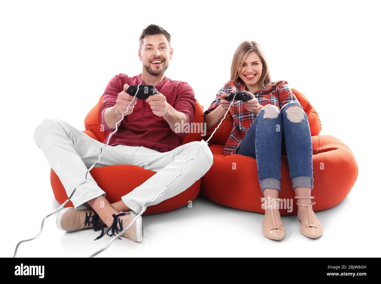 Happy couple playing video game on white background Stock Photo - Alamy
