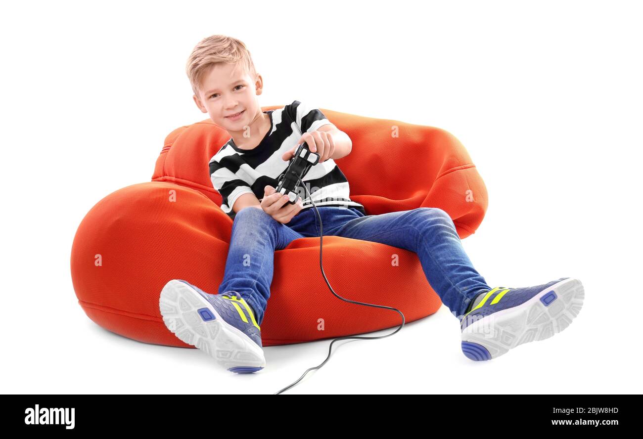 Cute boy playing video game on white background Stock Photo - Alamy