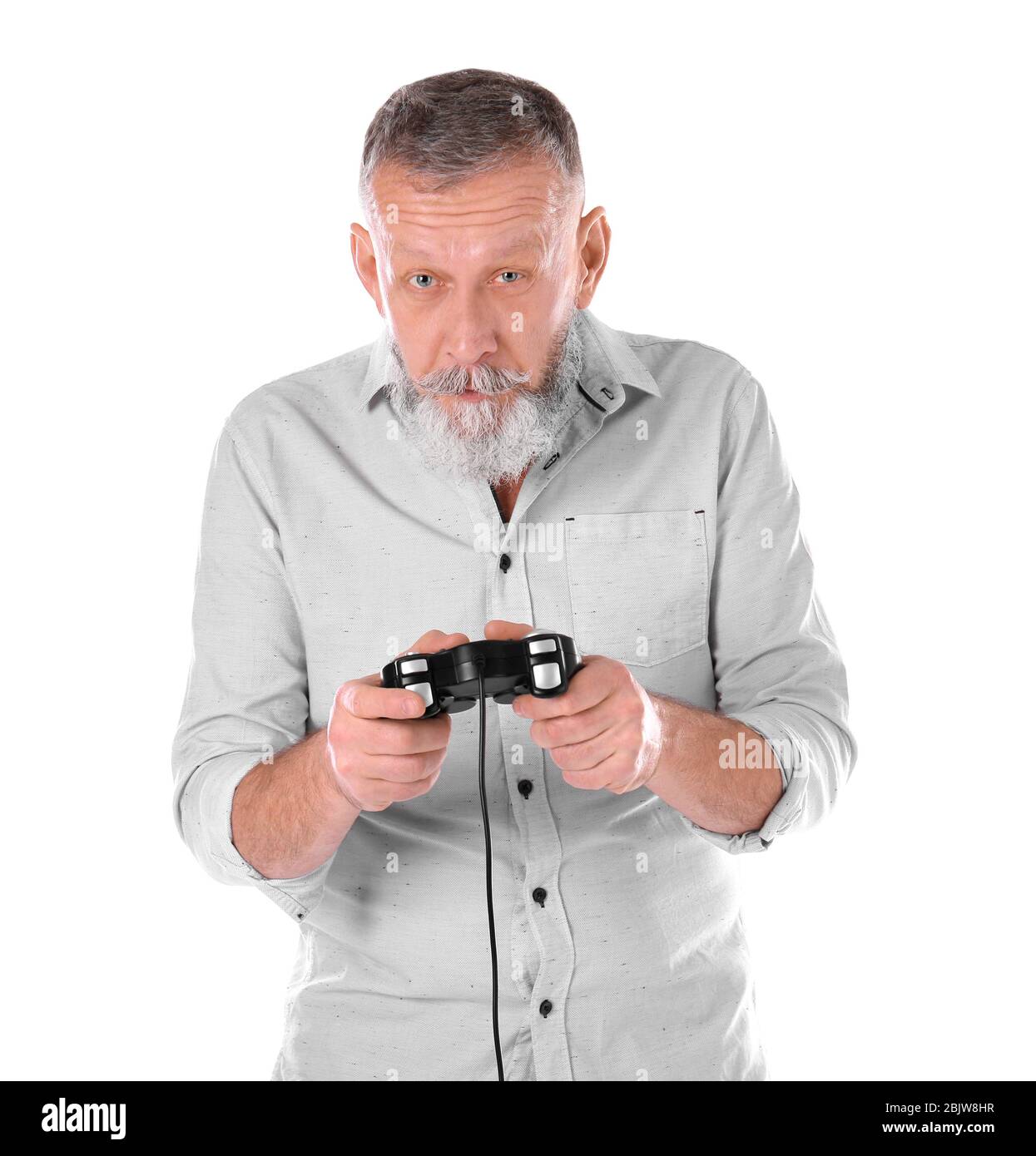 Emotional senior man playing video game on white background Stock Photo ...