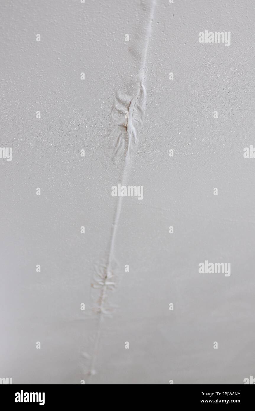White textured wall paint with water damage Stock Photo - Alamy