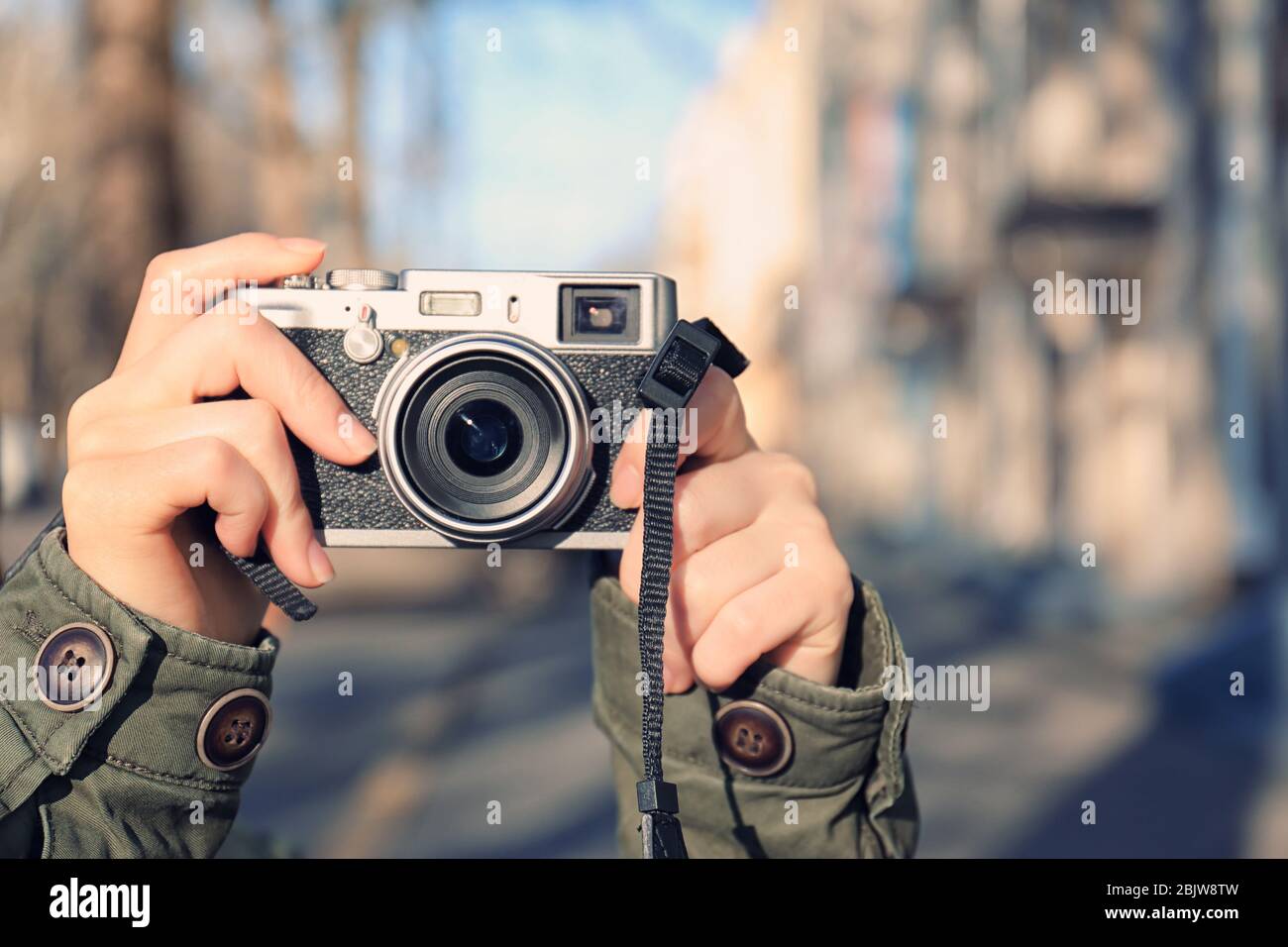 Female photographer with camera outdoors Stock Photo - Alamy