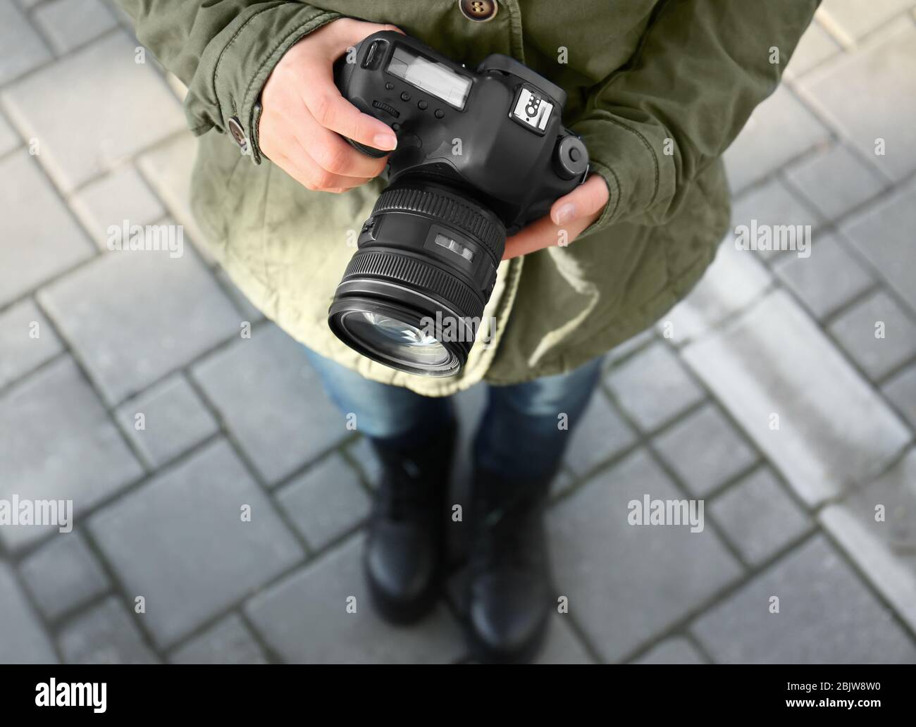 Female photographer with camera outdoors Stock Photo - Alamy