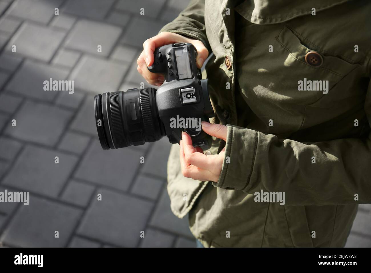 Female photographer with camera outdoors Stock Photo - Alamy